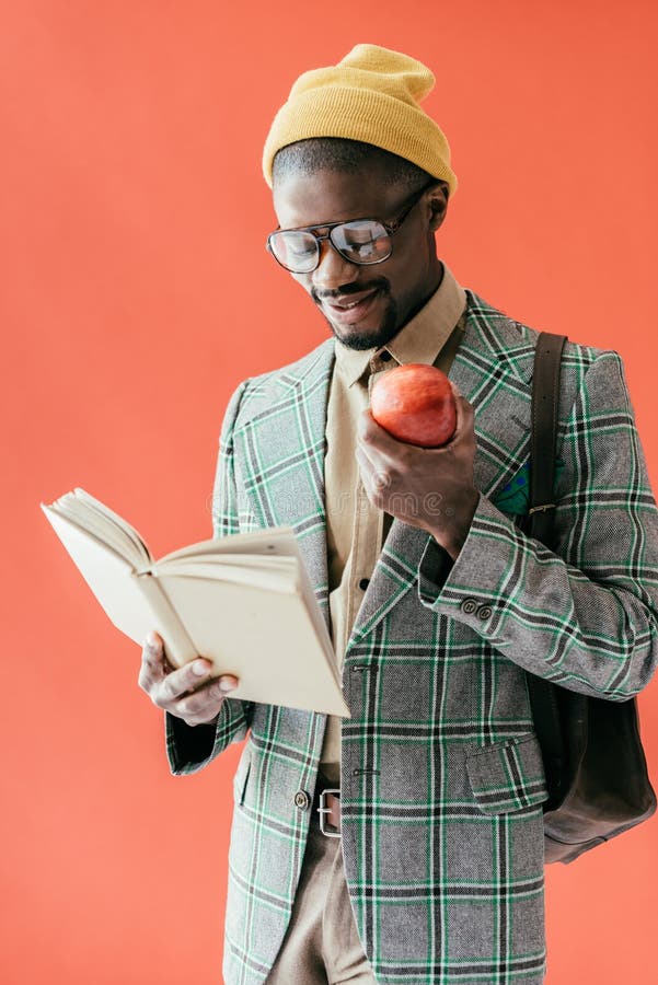 African American Man with Apple Reading Book Stock Image - Image of ...
