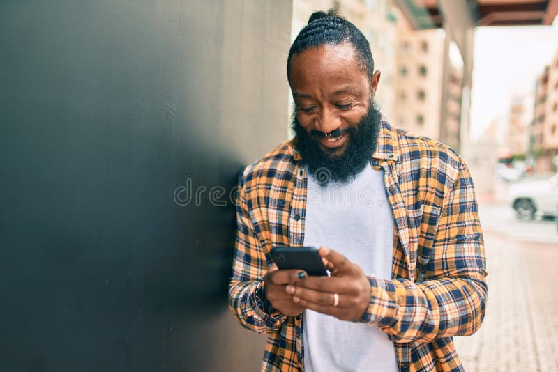 African American Man With Beard Using Smartphone Typing And Texting At
