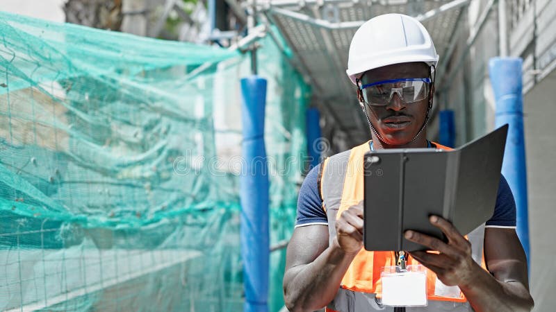 African American Man Builder Using Touchpad at Construction Place Stock ...
