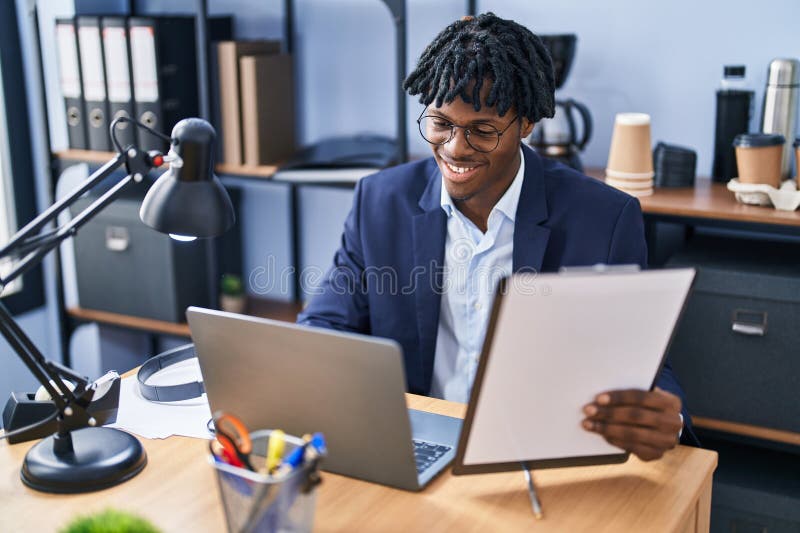 African American Man Business Worker Using Laptop Reading Document ...