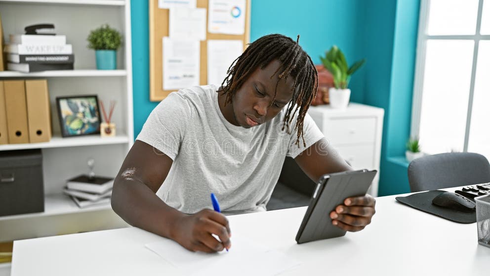African American Man Business Worker Using Touchpad Taking Notes at the ...