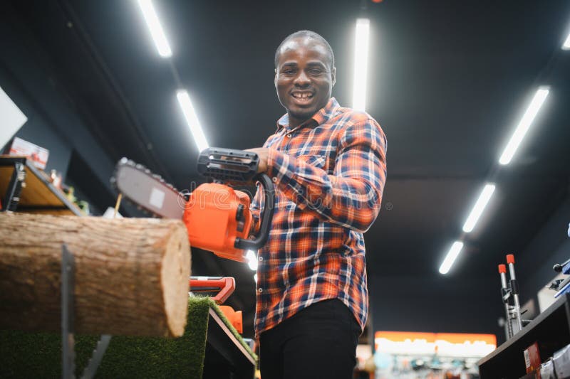African American Man is Choosing Electric Saw in Tools Store Stock ...