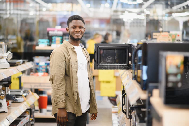 African American Man Choosing New Microwave Oven Electronics Store ...