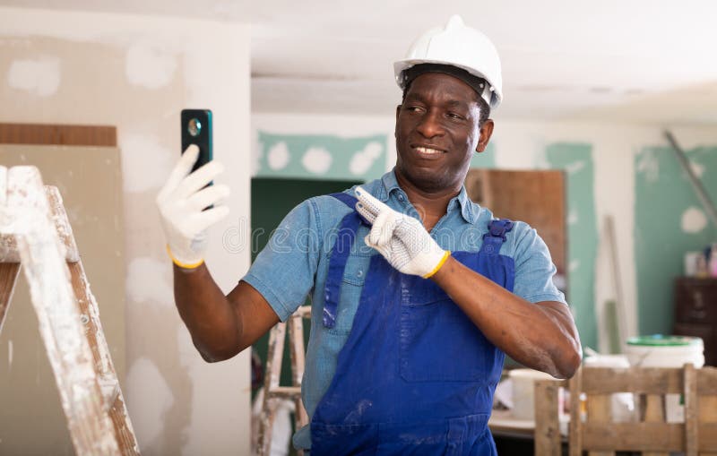 African-american Man Construction Worker Holding Document in Hand while ...