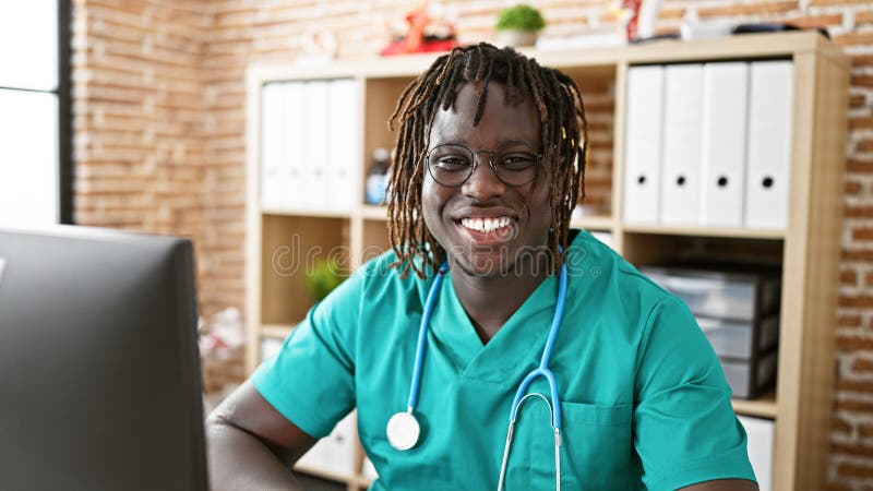 African American Man Doctor Using Computer Smiling at the Clinic Stock ... African American Man Doctor Using Computer Smiling at the Clinic Stock ...