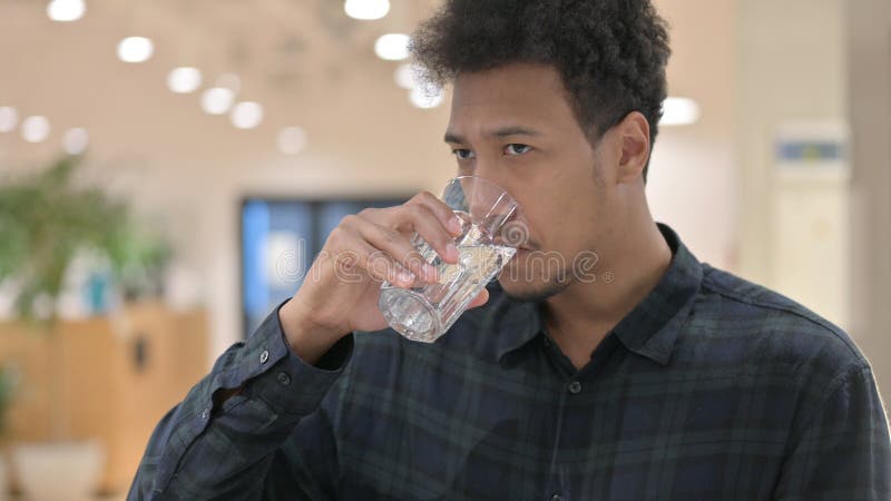 African American Man Drinking Water Stock Photo - Image of working ...