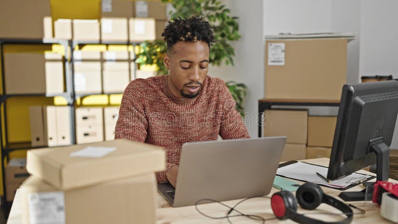 African American Man Ecommerce Business Worker Using Laptop Sitting on ...