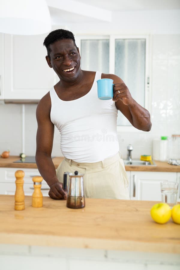 African American Man Pouring Coffee from Coffee Pot for Breakfast in ...