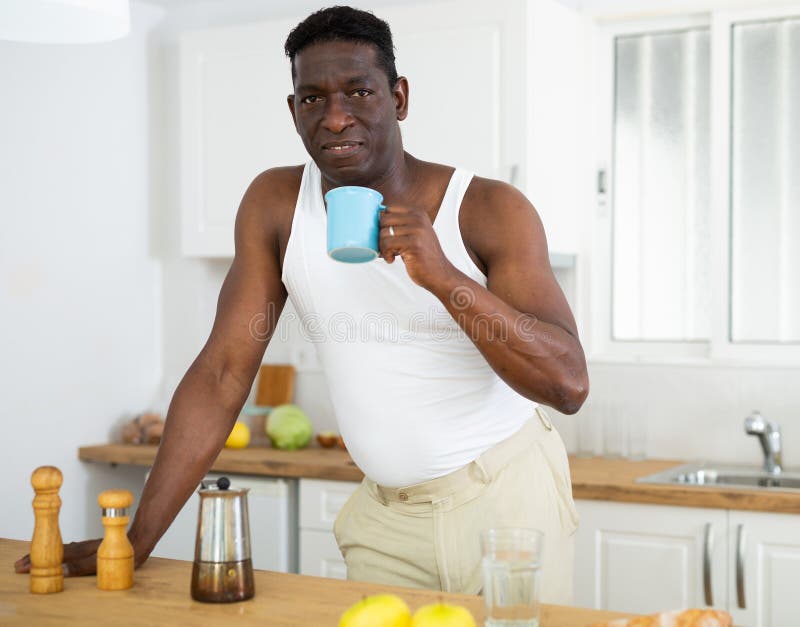 African American Man Pouring Coffee from Coffee Pot for Breakfast in ...