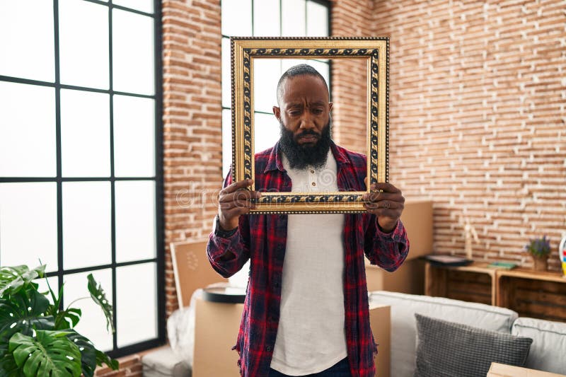 African American Man Putting Face in Empty Frame Depressed and Worry ...
