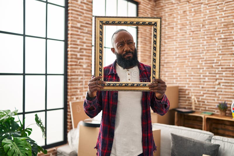 African American Man Putting Face in Empty Frame Smiling Looking To the ...