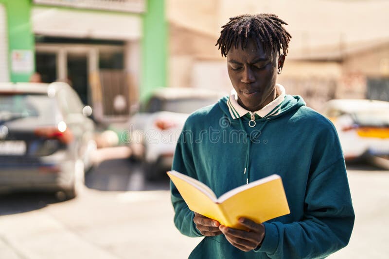 African American Man Reading Book at Street Stock Image - Image of ...