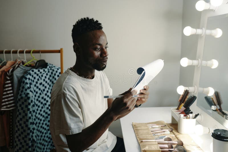 African American Man Reading Script in Dressing Room Stock Photo ...