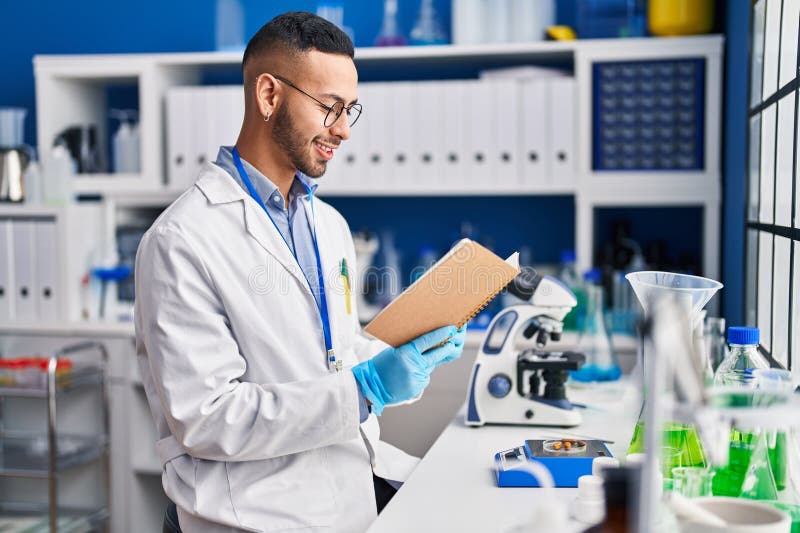 African American Man Scientist Reading Book Working at Laboratory Stock ...