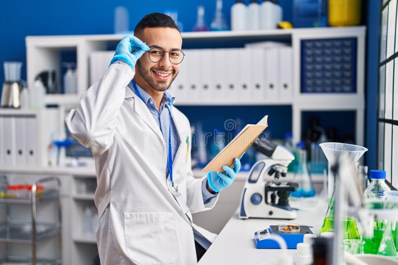 African American Man Scientist Reading Book Working at Laboratory Stock ...