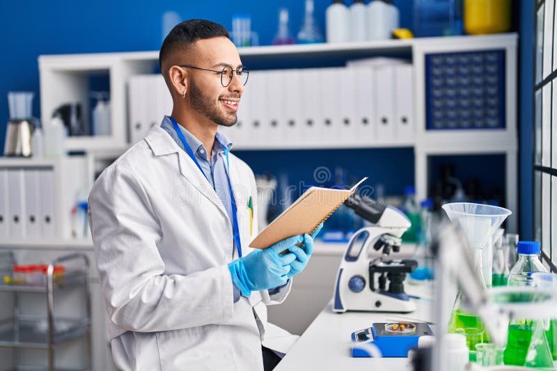African American Man Scientist Reading Book Working at Laboratory Stock ...