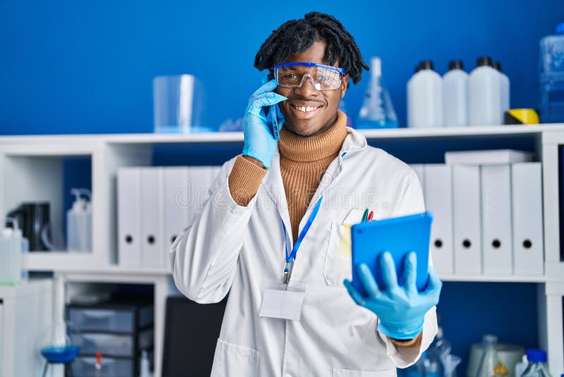 African American Man Scientist Talking on the Smartphone Using Touchpad ...