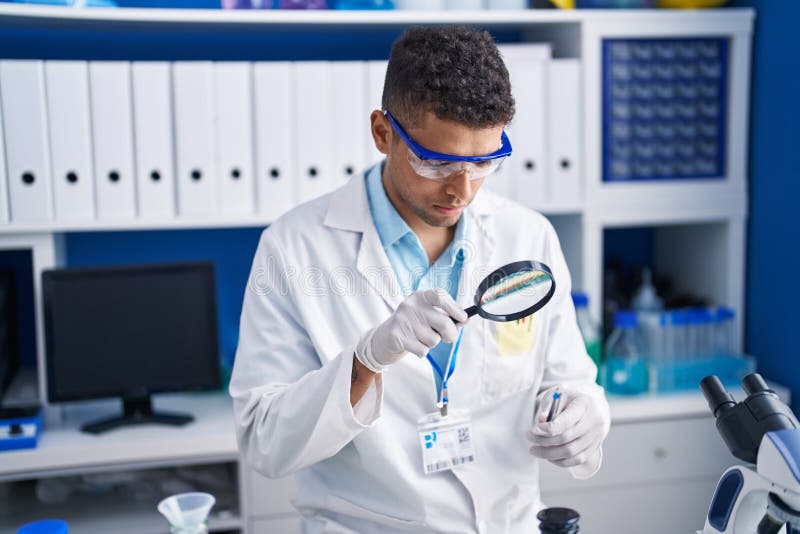 African American Man Scientist Using Magnifying Glass Working at ...