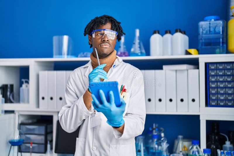 African American Man Scientist Using Touchpad at Laboratory Stock Photo ...