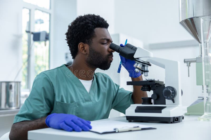 African American Man Scientist Working with Microscope Laboratory ...