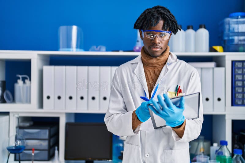 African American Man Scientist Writing on Clipboard at Laboratory Stock ...