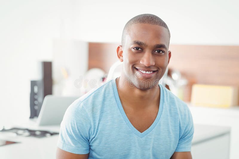 African American Man Sitting while Smiling at Countertop in Home ...