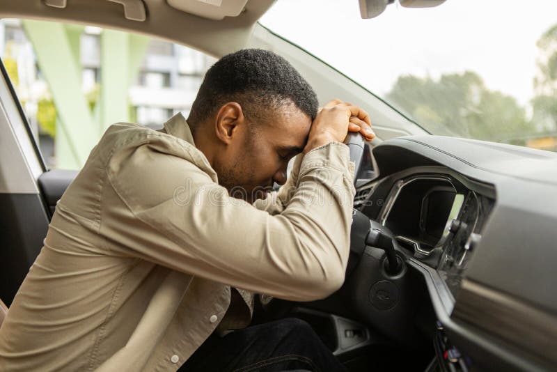 African American Man Sleeping in a Car, Resting Head on Wheel Stock ... African American Man Sleeping in a Car, Resting Head on Wheel Stock ...