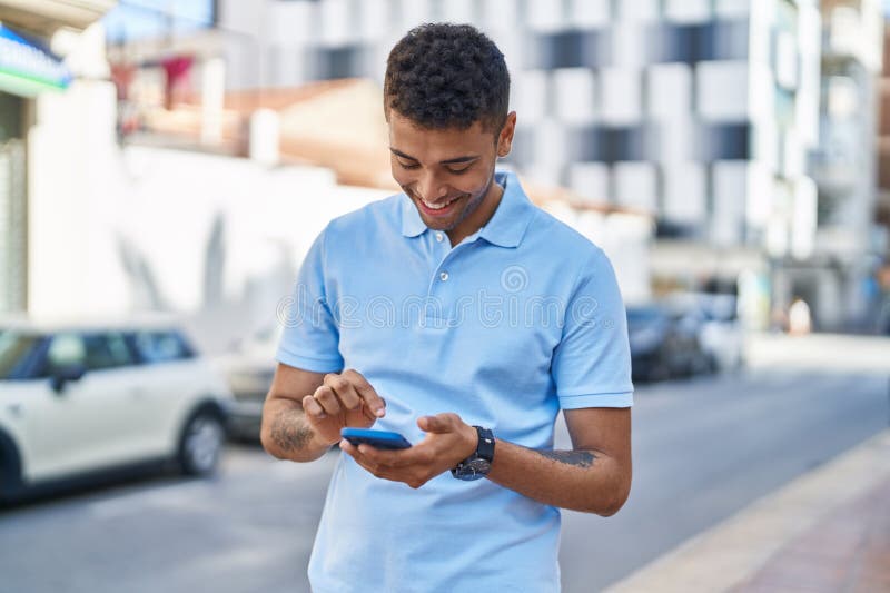 African American Man Smiling Confident Using Smartphone at Street Stock ...