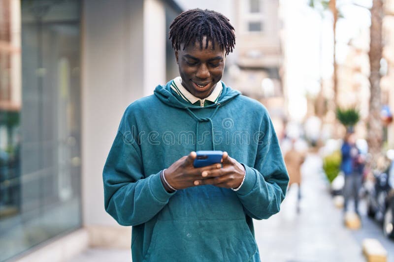 African American Man Smiling Confident Using Smartphone at Street Stock ...