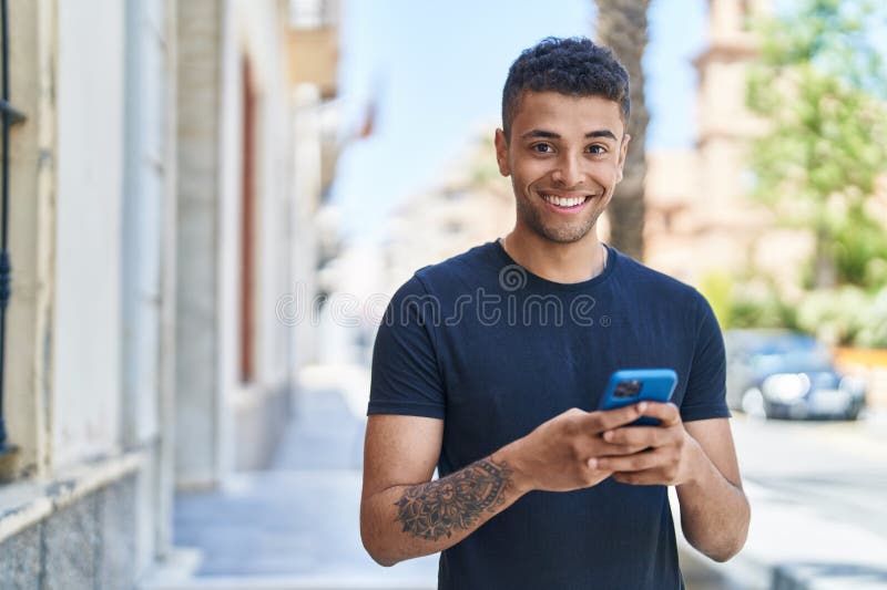 African American Man Smiling Confident Using Smartphone at Street Stock ...