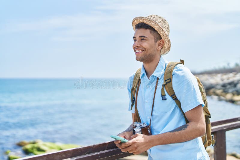 African American Man Tourist Smiling Confident Using Smartphone at ...