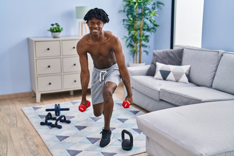 African American Man Training Legs Exercise Using Dumbbells at Home ...