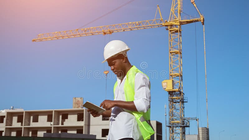 African American Man Types Report about Building at Sunlight Stock ...