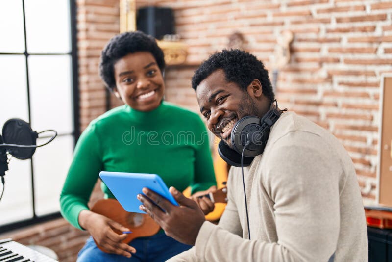 African American Man and Woman Music Group Using Touchpad Playing ...