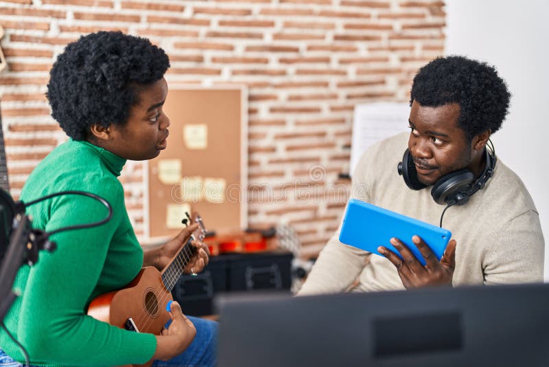 African American Man and Woman Music Group Using Touchpad Playing ...