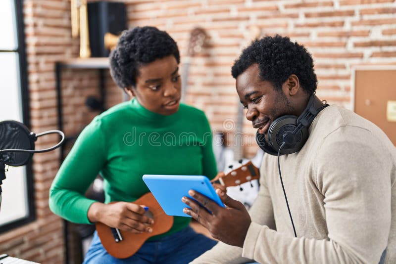 African American Man and Woman Music Group Using Touchpad Playing ...