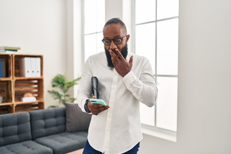 African American Man Working At Therapy Office Using Smartphone
