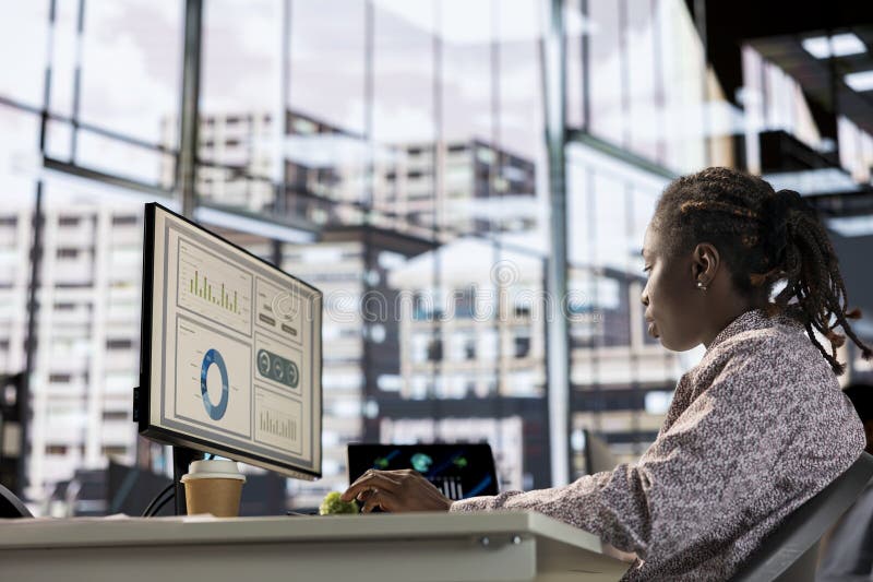 African American Manager Analyzing Company Data for Strategic Planning ...