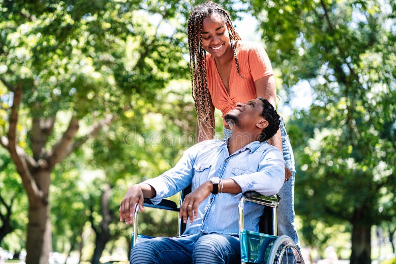 Man in a Wheelchair Enjoying a Walk with His Girlfriend. Stock Image ... Man in a Wheelchair Enjoying a Walk with His Girlfriend. Stock Image ...