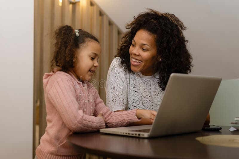 African American Mother and Daughter Using a Laptop Stock Image - Image ...