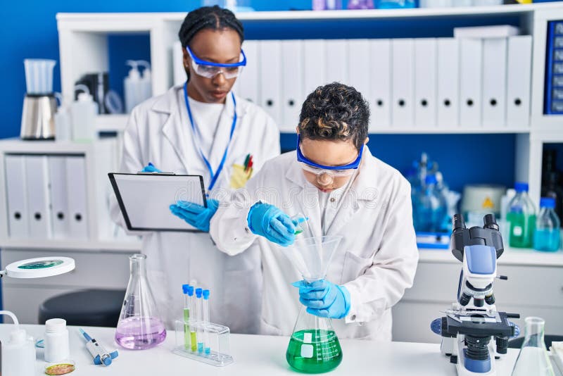 African American Mother and Son Scientists Measuring Liquid Laboratory ...