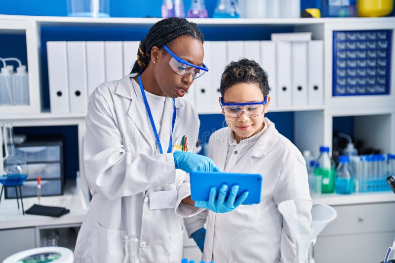 African American Mother and Son Scientists Using Touchpad Working ...