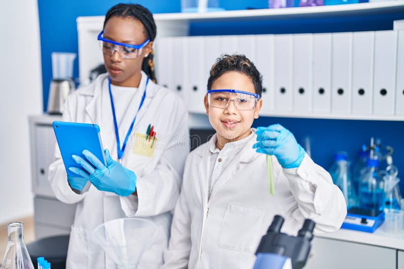 African American Mother and Son Scientists Using Touchpad Working ...
