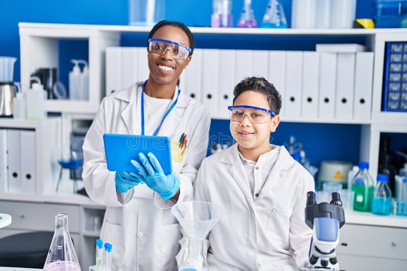 African American Mother and Son Scientists Using Touchpad Working ...