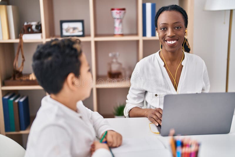 African American Mother and Son Teleworking and Studying at Home Stock ...