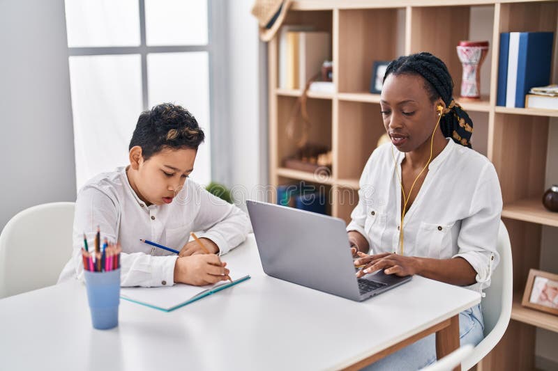 African American Mother and Son Teleworking and Studying at Home Stock ...