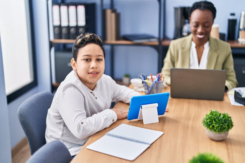 African American Mother and Son Using Laptop and Touchpad Working at ...