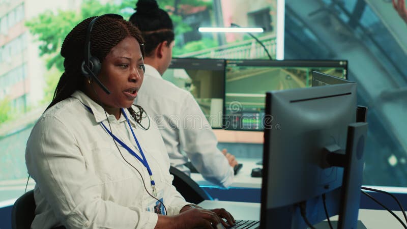 African American Operator Works with Isolated Display and Satellite Map ...