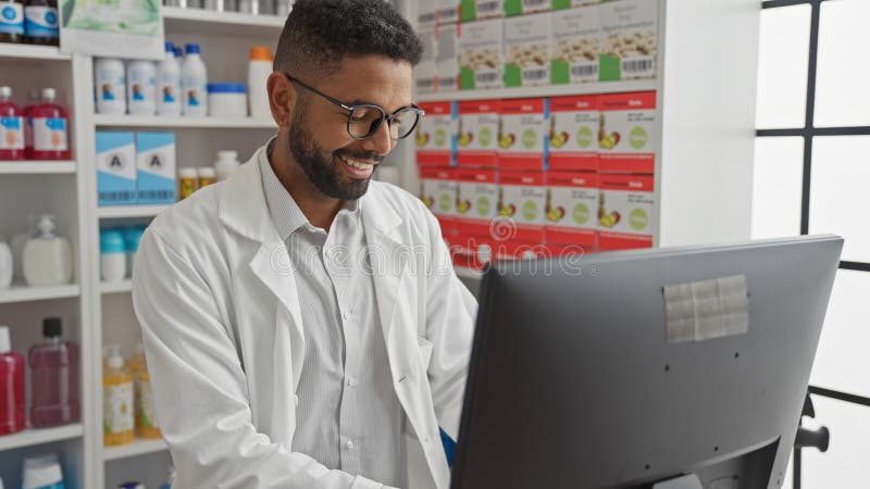 African American Pharmacist Smiling while Using Computer in Modern ...