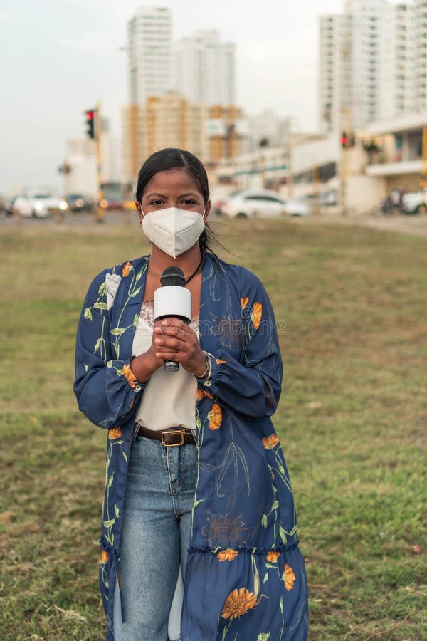 African American Presenter in Face Mask Speaking into Microphone while ...